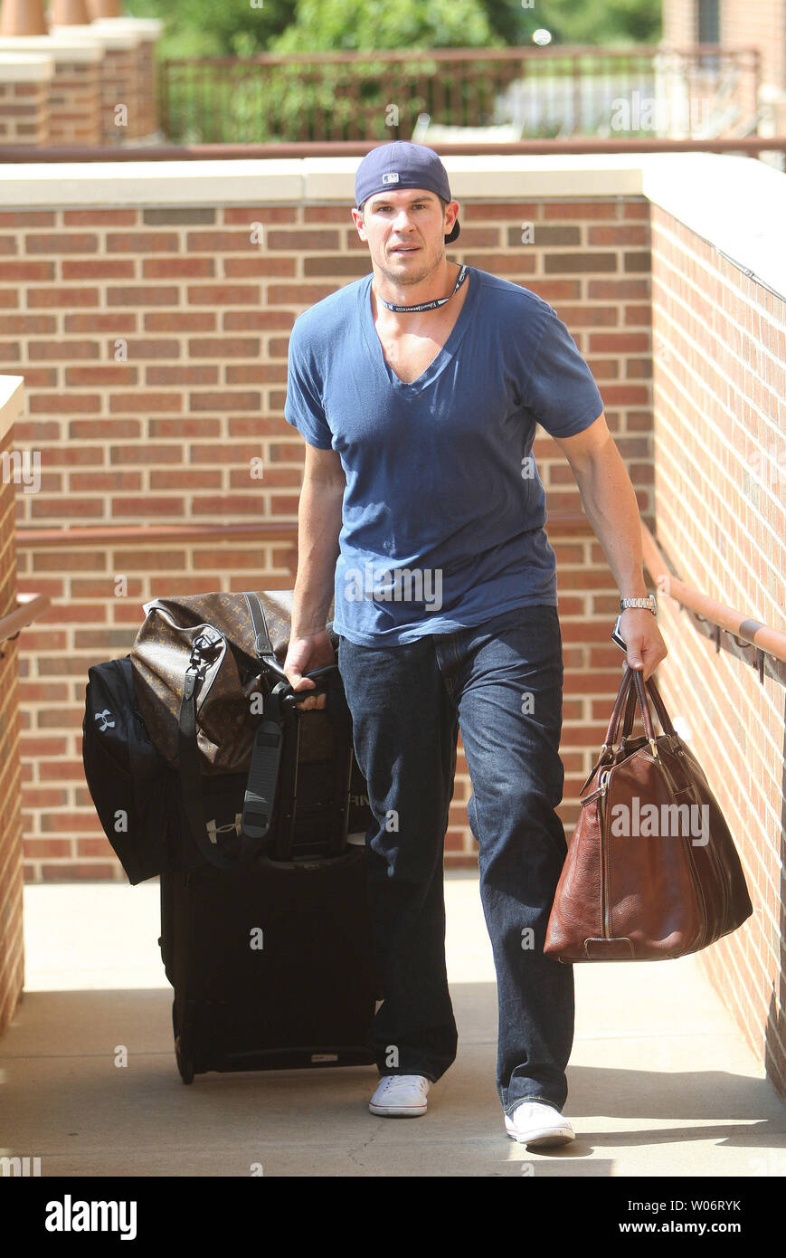 St. Louis Rams quarterback A. J. Feeley wheels his belongings into the ...