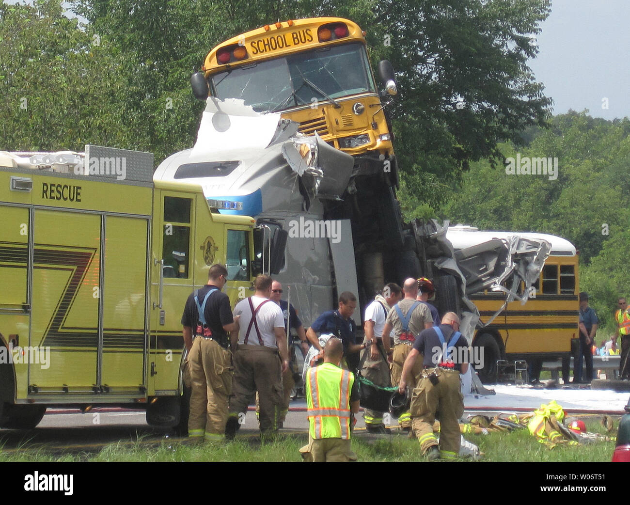 Firefighters work a school bus accident that killed two and injured nearly 50 children in a ...