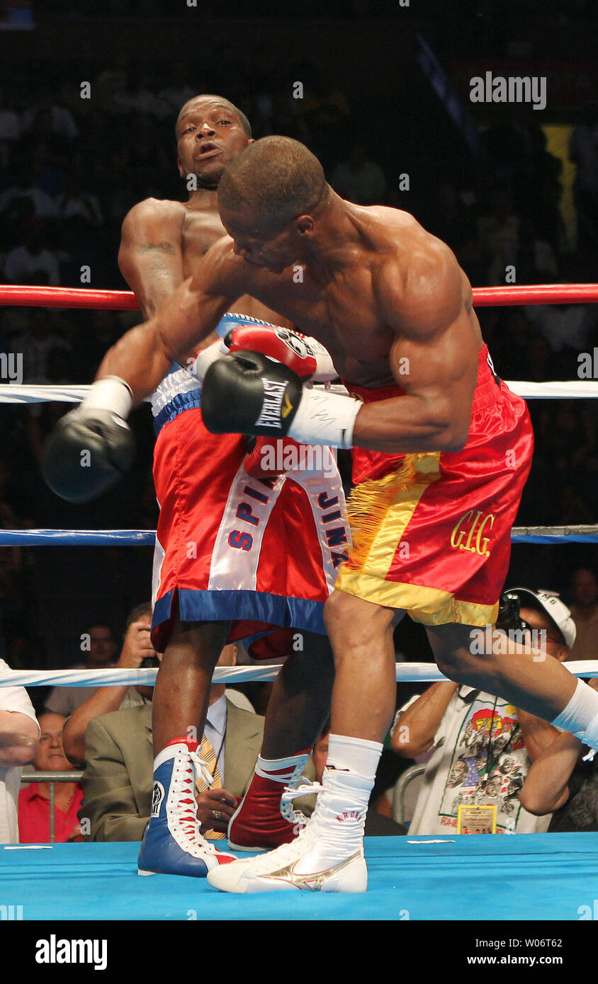 Boxer Cory Spinks (L) falls against the ropes after a hit to the face ...