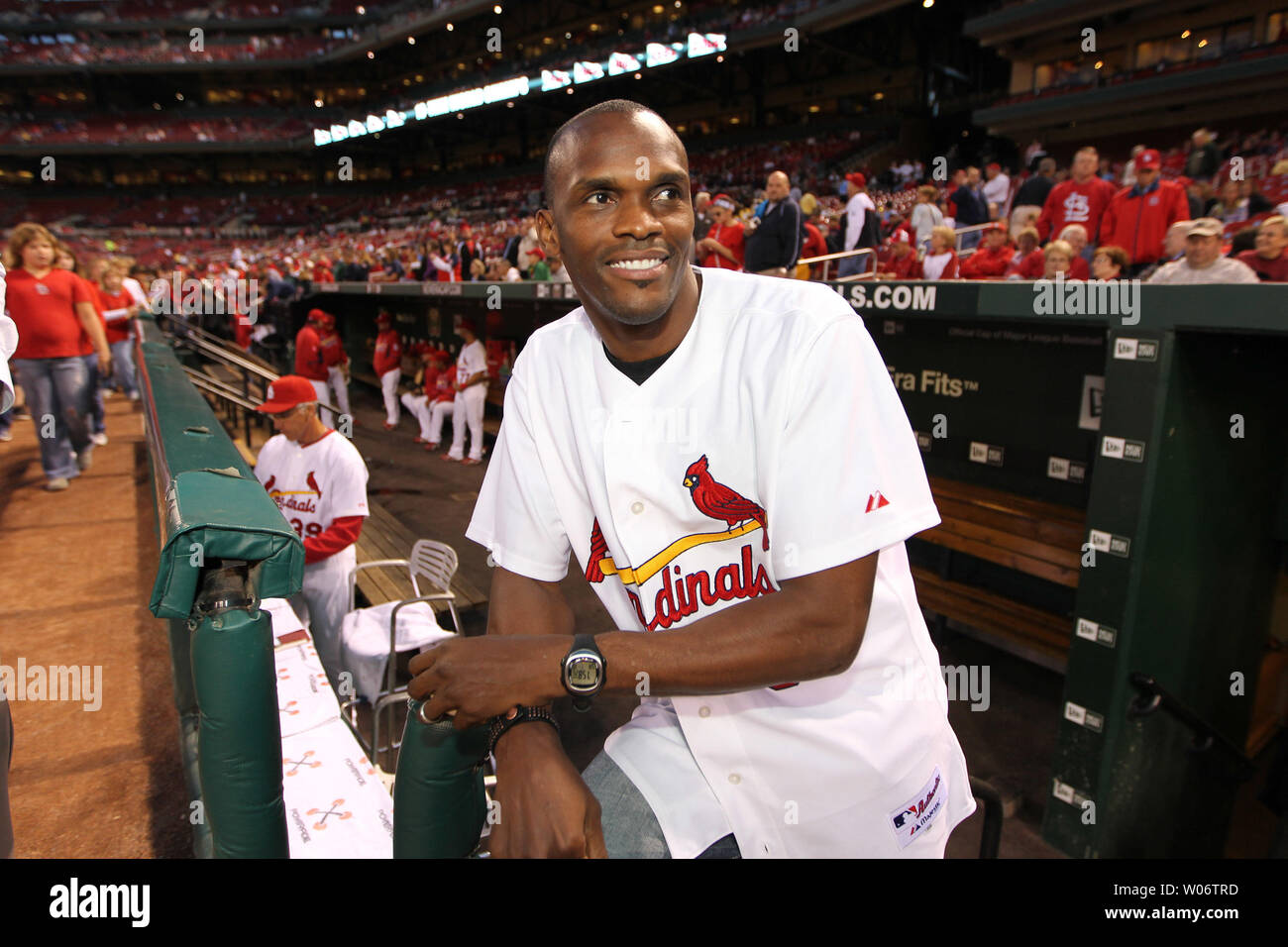 Former NFL wide receiver Isaac Bruce waits in the dugout before the ...