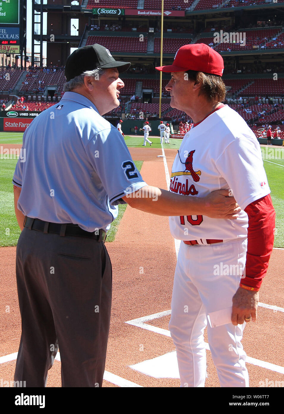 Umpire Jerry Crawford (L) is greeted at homeplate by St. Louis ...