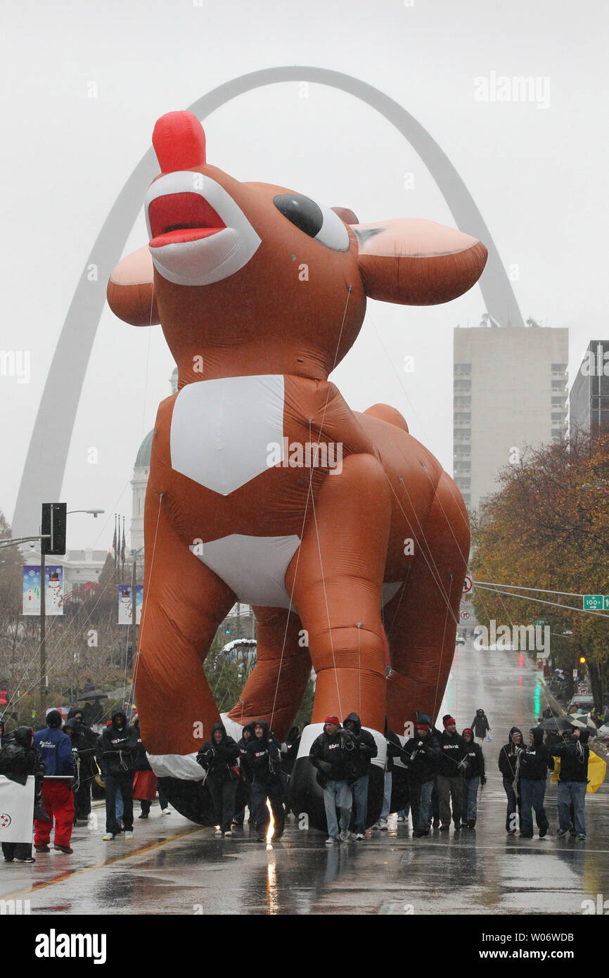 Volunteers fight a strong wind and a freezing rain to keep Rudolph the ...