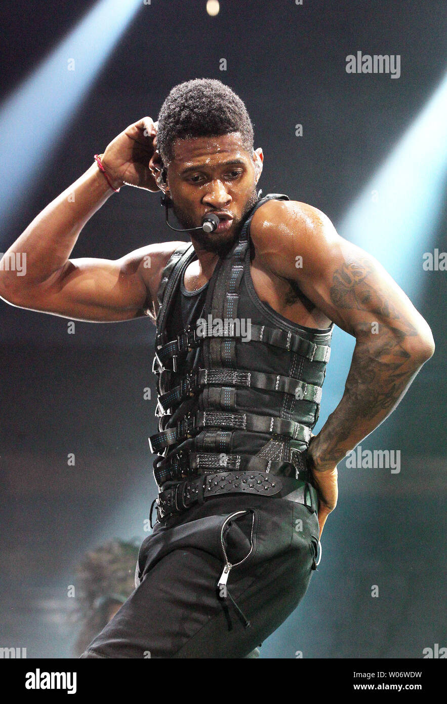 Singer Usher performs on stage at the Scottrade Center in St. Louis on ...