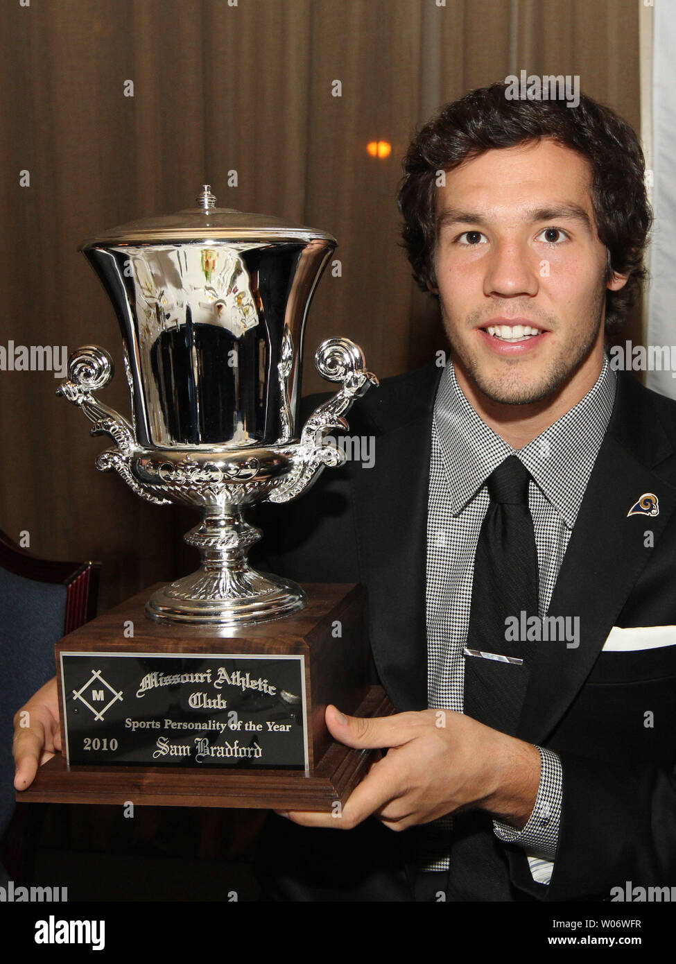 St. Louis Rams quarterback Sam Bradford holds his trophy after being ...