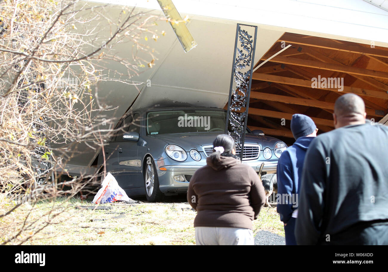 Joelle Fouse and her family members look at the garage that collaspsed ...