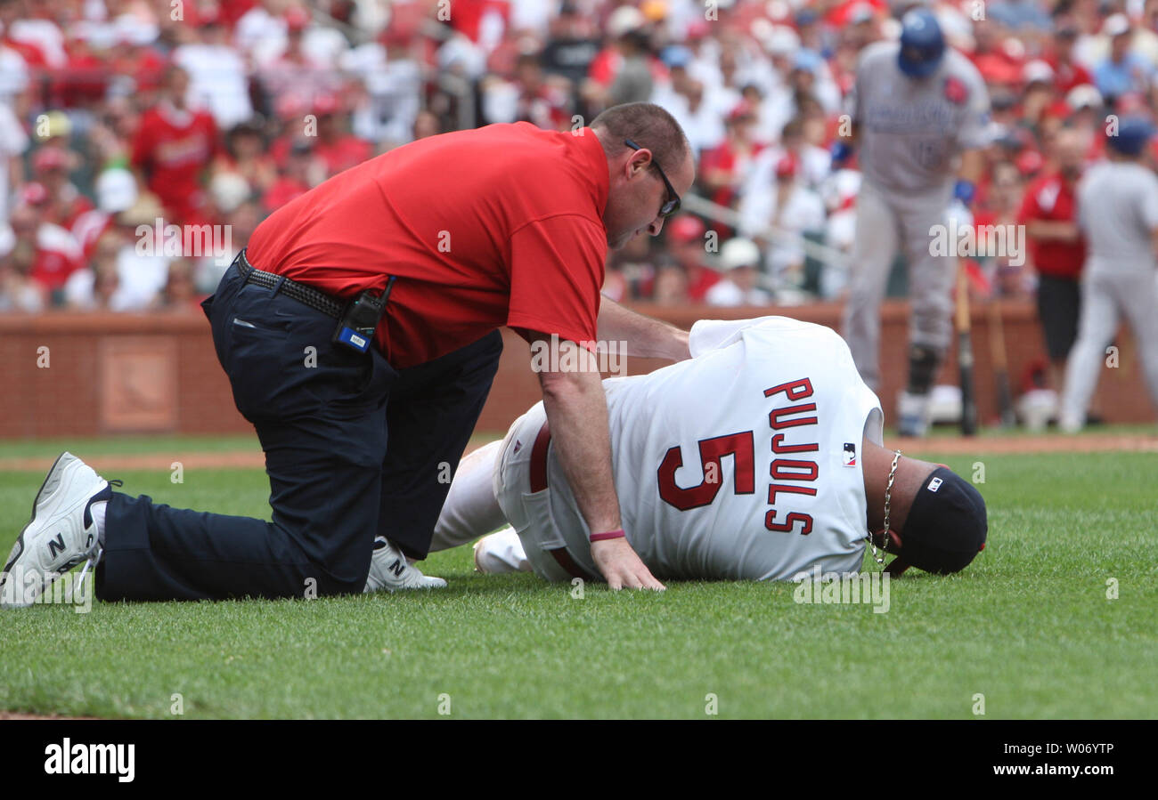 St. Louis Cardinals Albert Pujols rolls on the ground in pain as head ...