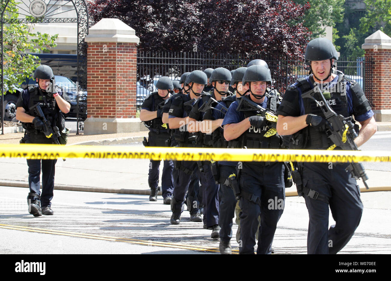 Members of the St. Louis Police Department's Swat team trot across the ...