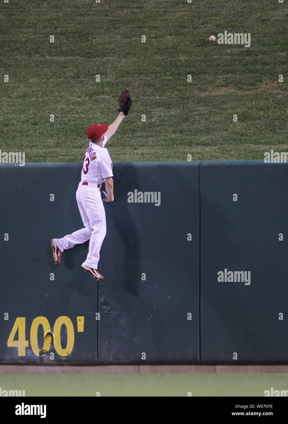 St. Louis Cardinals center fielder Shane Robinson scales the wall in an ...