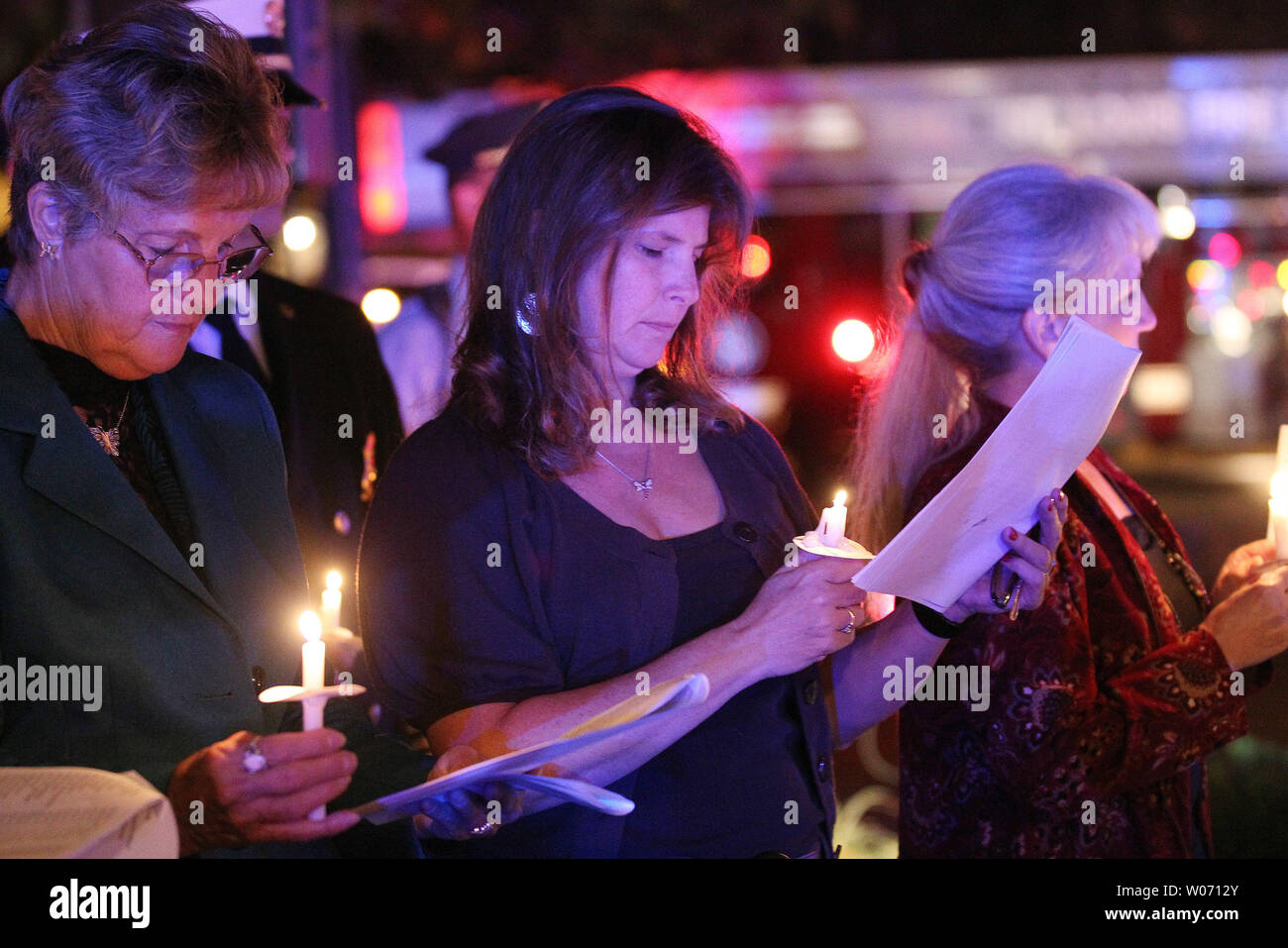 Laura Morrison, (C) whose St. Louis Fire Department husband was killed ...