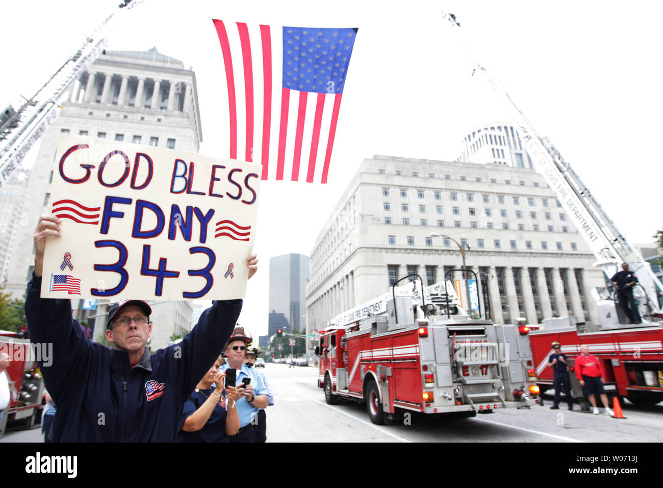 Retired Chicago firefighter Brian Murphy holds a sign as a tribute to ...