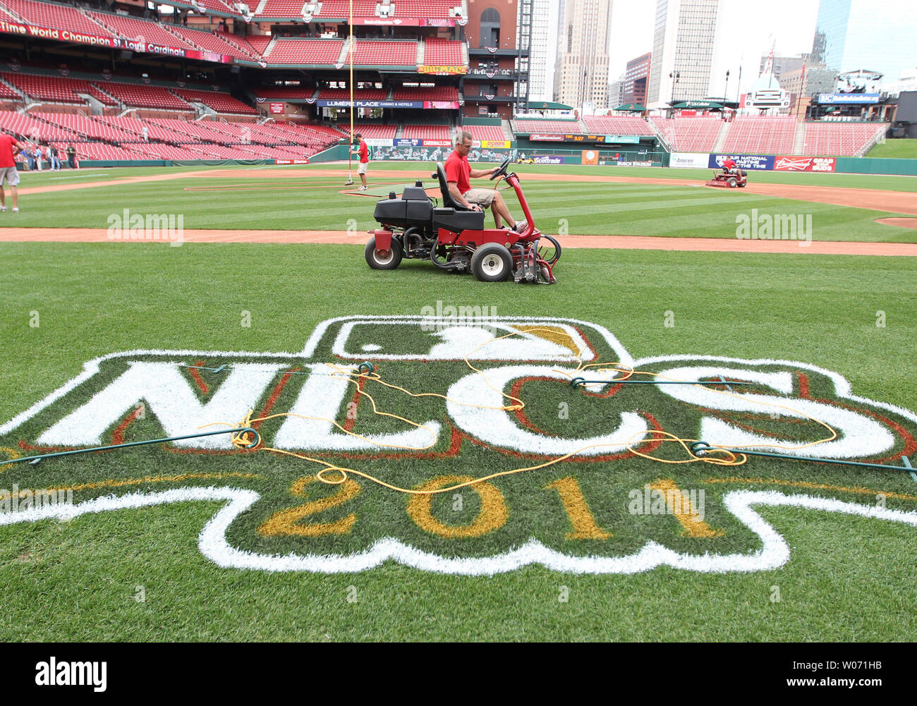 Busch Stadium grounds keeper Justin Hatcher cuts the grass on the ...