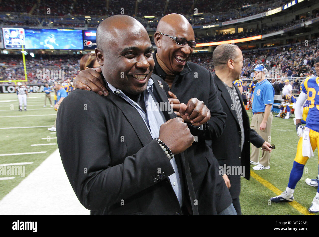Football Hall of Fame member Eric Dickerson (R) jokes with fellow ...