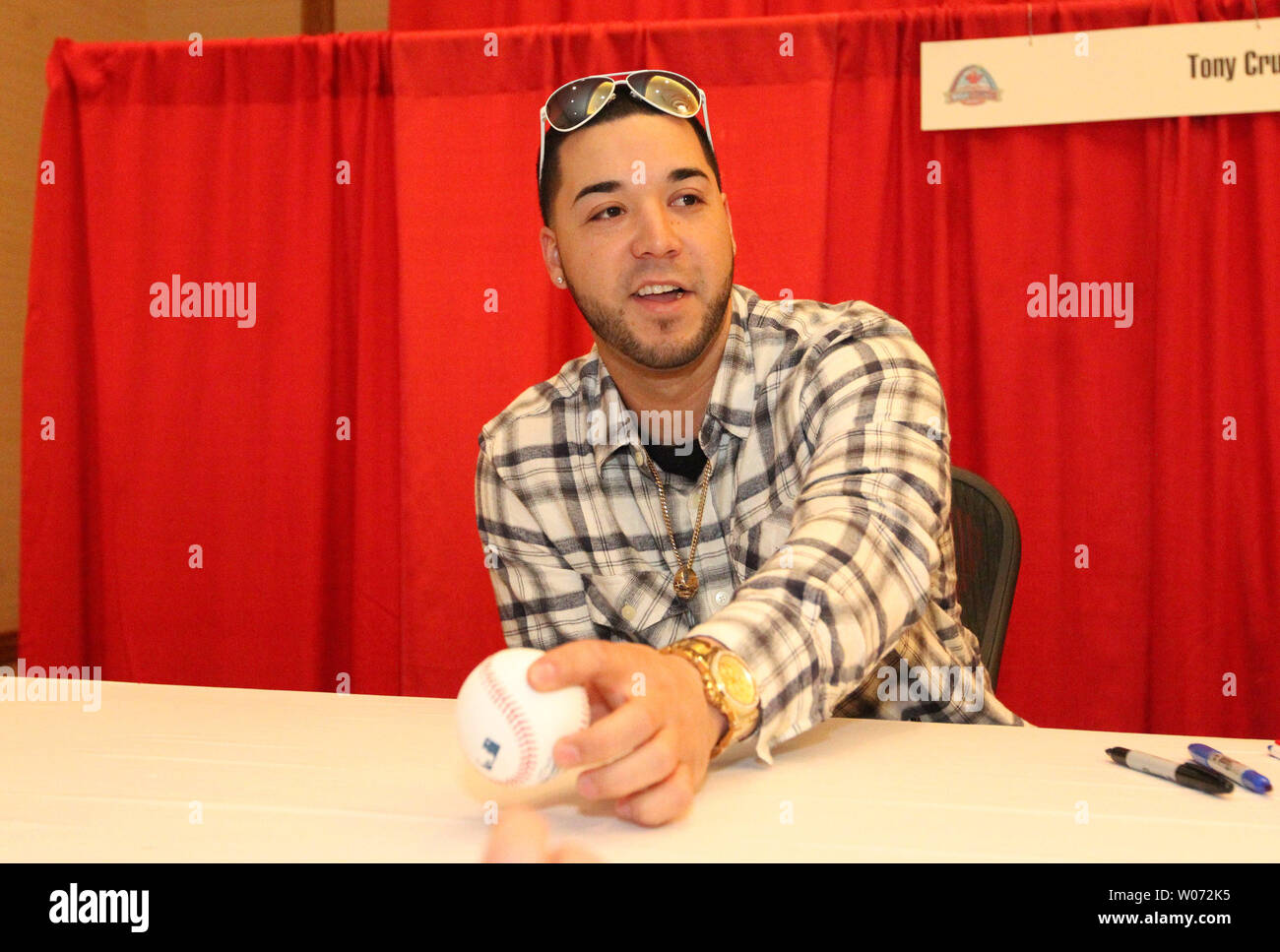 St. Louis Cardinals catcher Tony Cruz autographs a baseball for fans ...