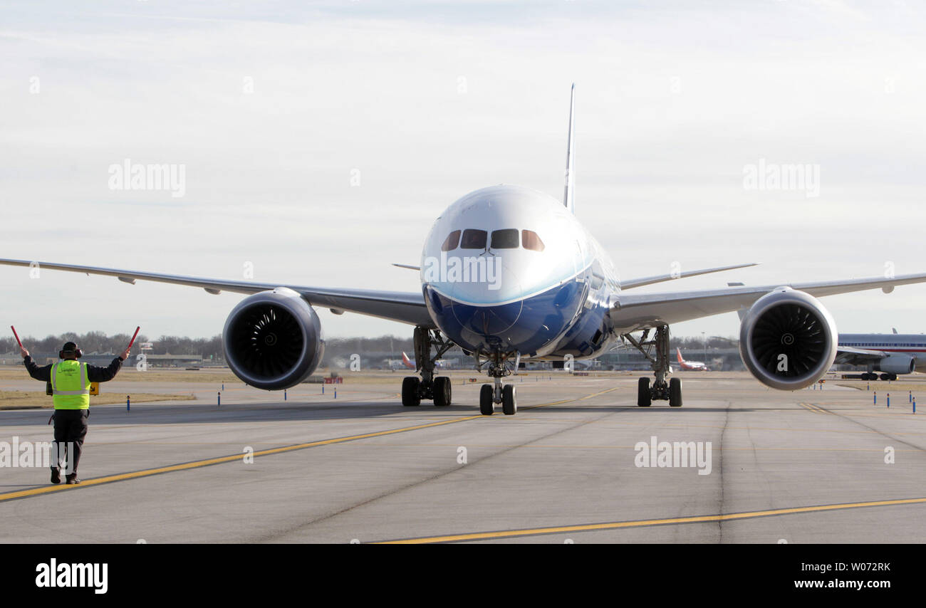 A Boeing 787 Dreamliner is guided on the tarmac at Lambert -St. Louis ...