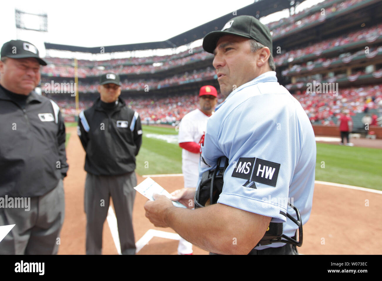 Homeplate umpire Phil Cuzzi gives last minute instructions to his crew ...