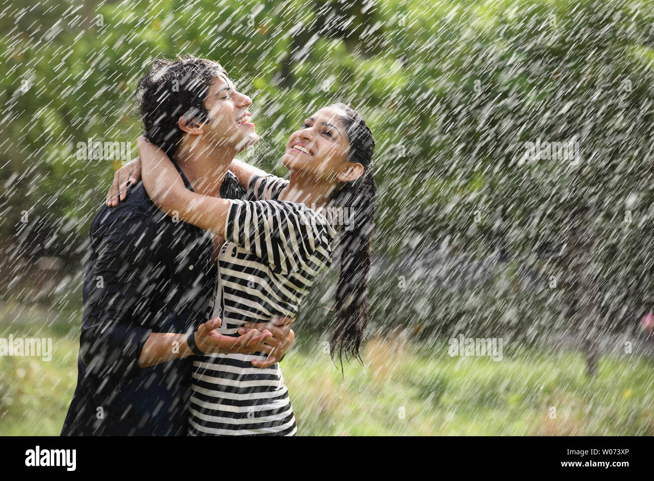 Indian couple romancing in the rain Stock Photo - Alamy