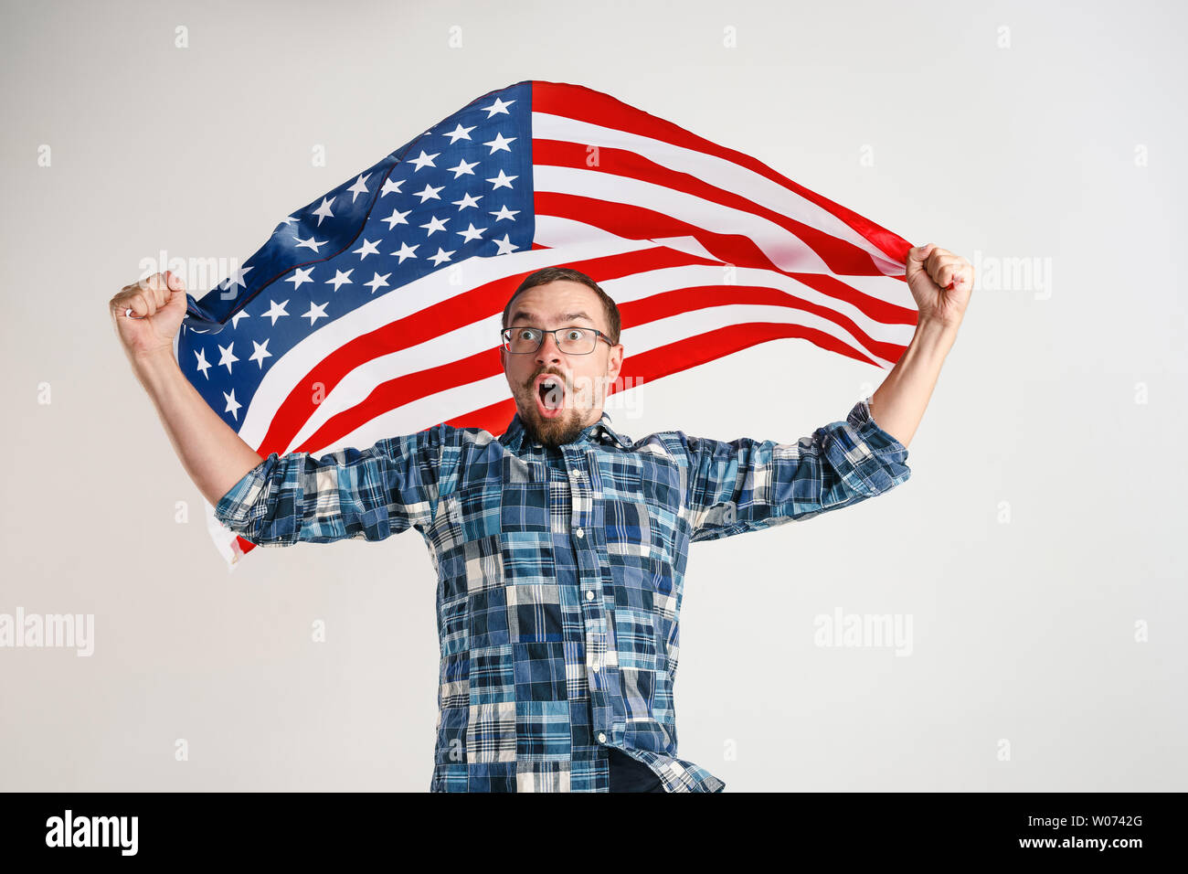 Celebrating an Independence day. Stars and Stripes. Young man with the ...