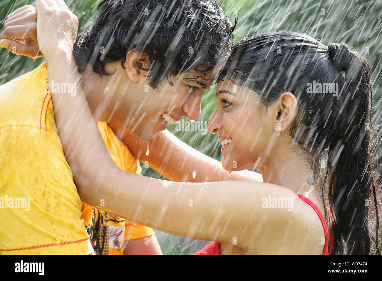 Indian young couple romancing in the rain Stock Photo - Alamy