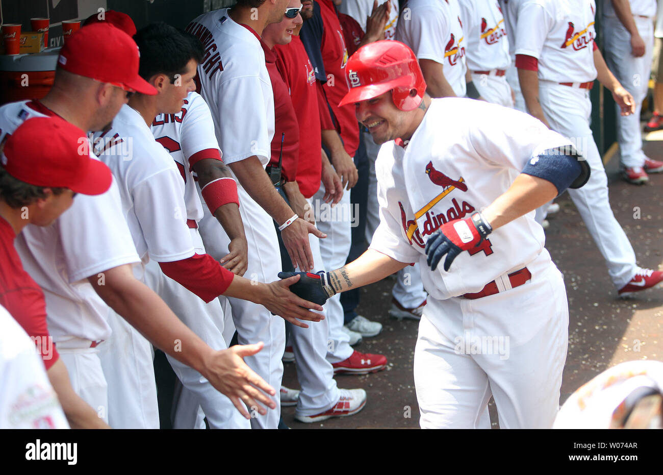 St. Louis Cardinals Yadier Molina is congratulated in the dugout after ...