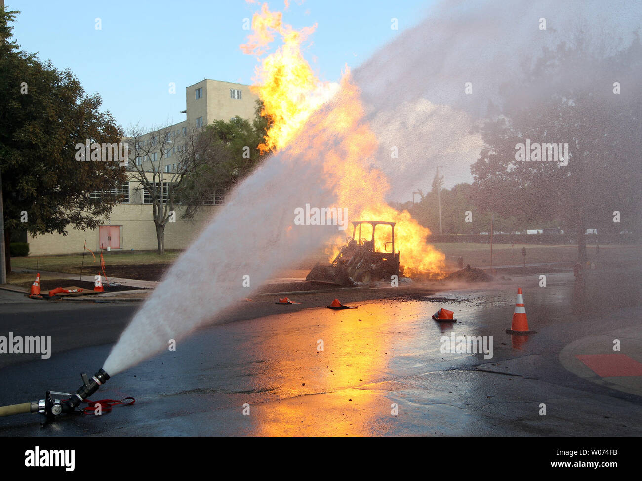 A St. Louis Fire Department master stream protects a building as a gas ...