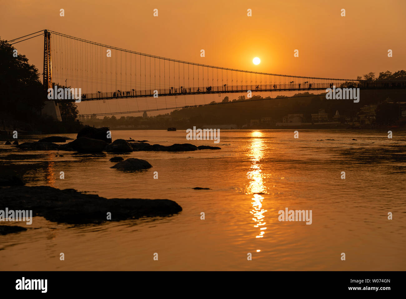 Beautiful view of Ganges river water embankment and bridge at sunset ...
