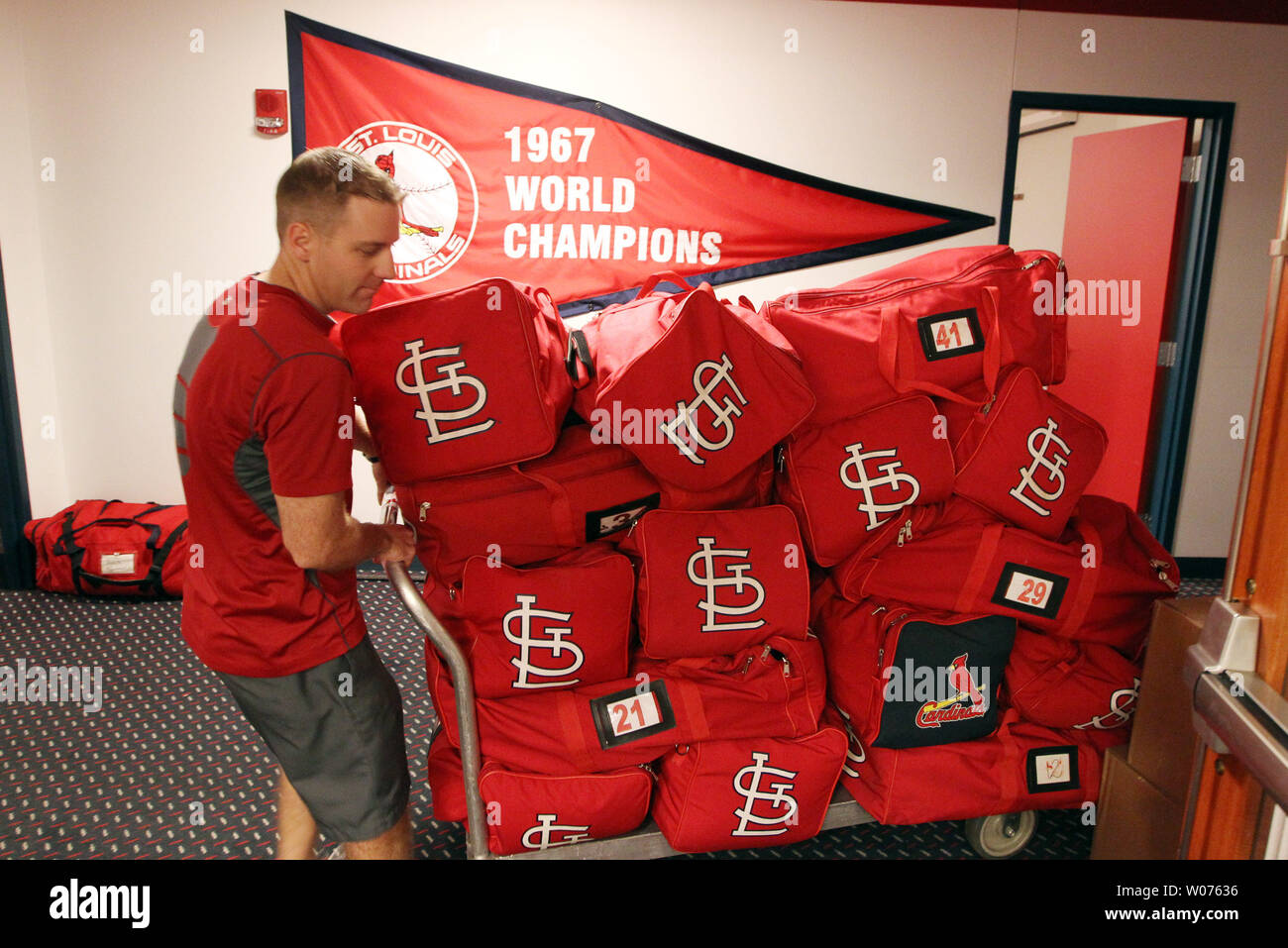St. Louis Cardinals clubhouse attendant Nate Pfitser wheels in travel ...