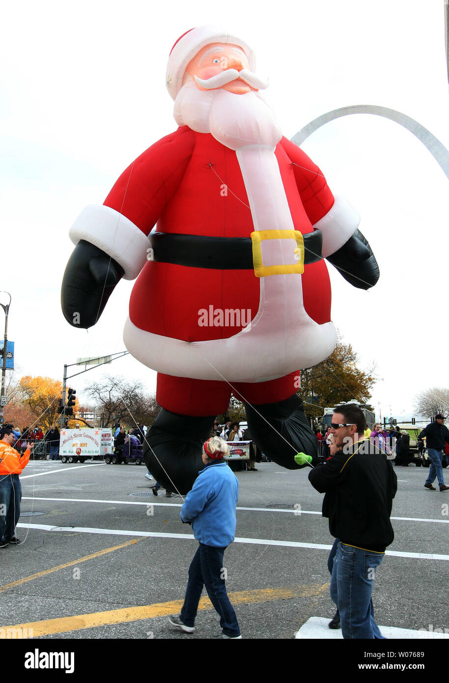 A Santa Claus balloon is towed past the Gateway Arch during the annual ...