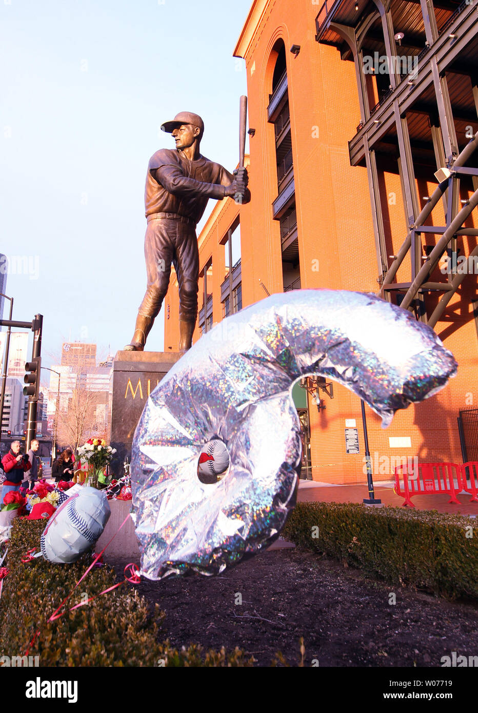 A number 6 balloon blows in the wind around the Stan Musial statue ...