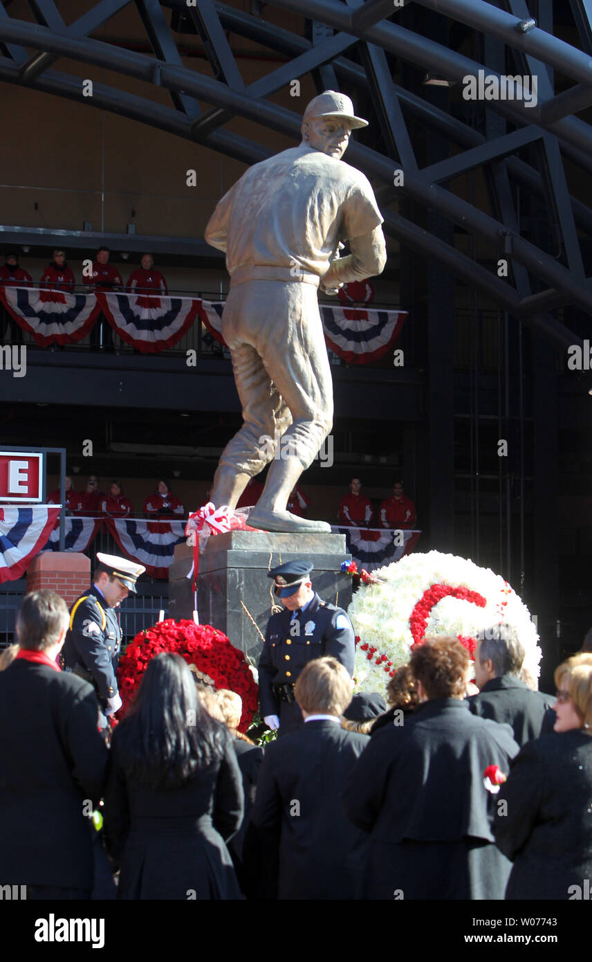 Family members pause to lay a wreath at the foot of the Stan Musial ...