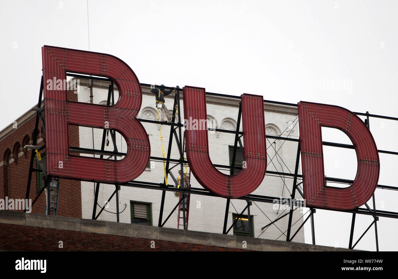 Workers stand among the Budweiser sign atop the Bevo building at the ...