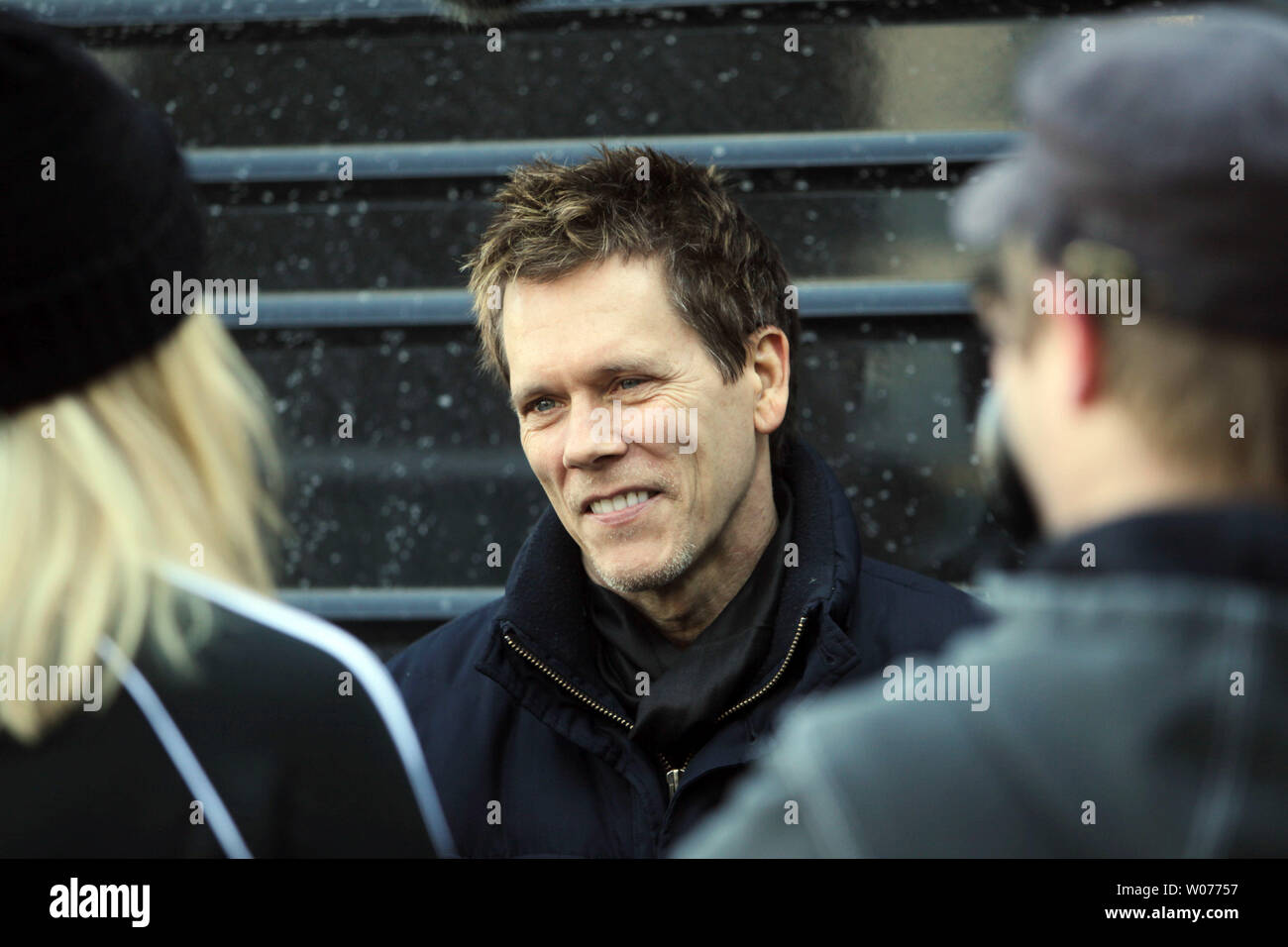 Actor Kevin Bacon talks with friends before going on stage to play in ...