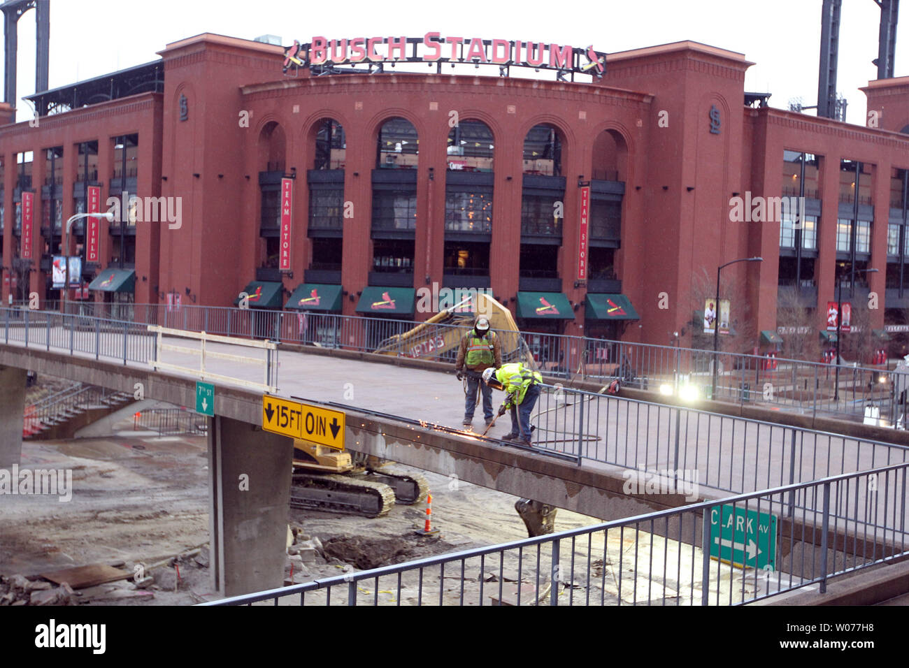 Construction workers use a welding torch to remove railing on the ...