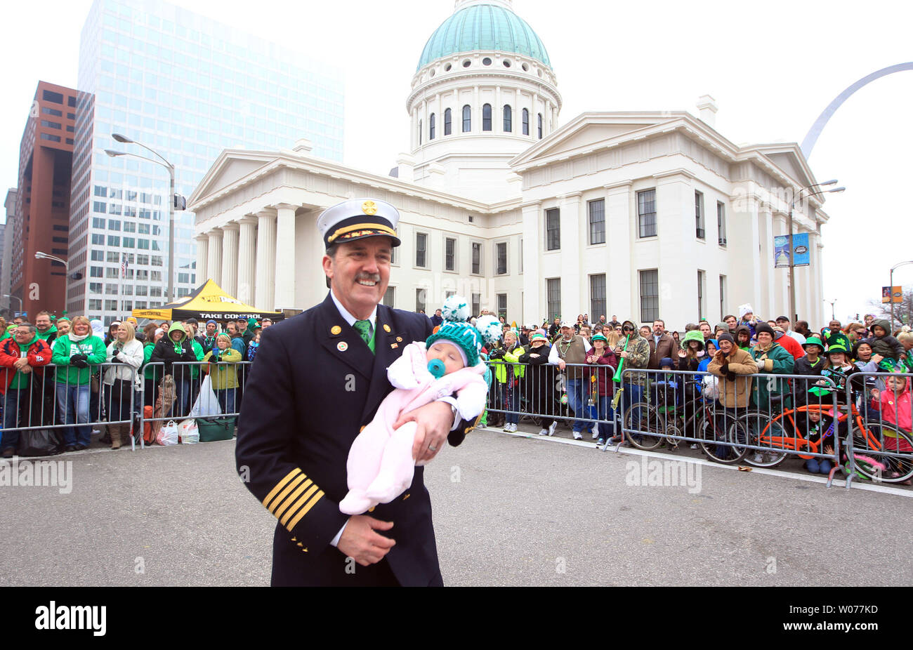 St. Louis Fire Chief Dennis Jenkerson, carries his four month old ...