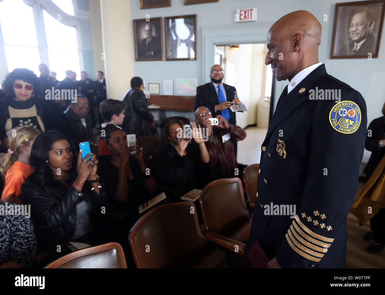 Newly installed University City Fire Chief Adam Long stands for family ...