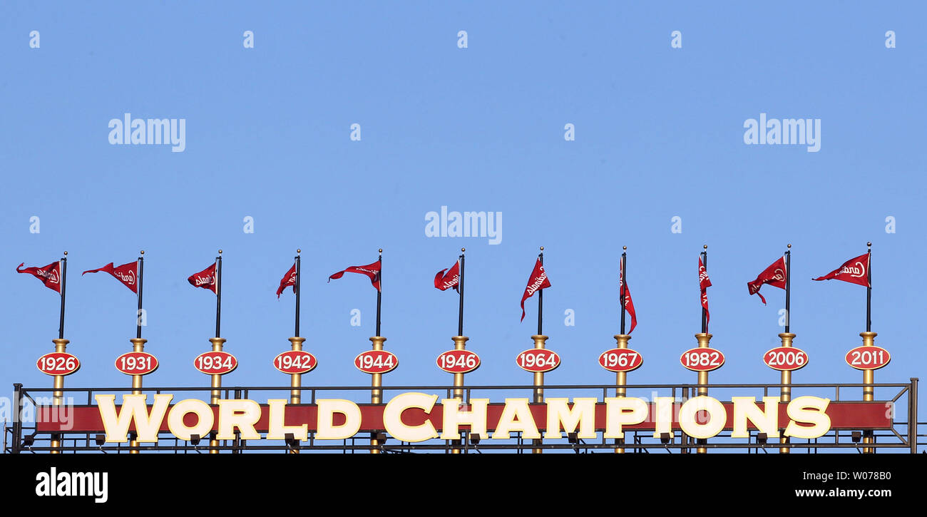 The World Championship flags blow atop Busch Stadium in a light breeze ...