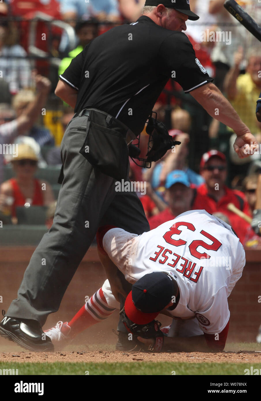 St. Louis Cardinals David Freese ends up wrapped around the leg of home ...