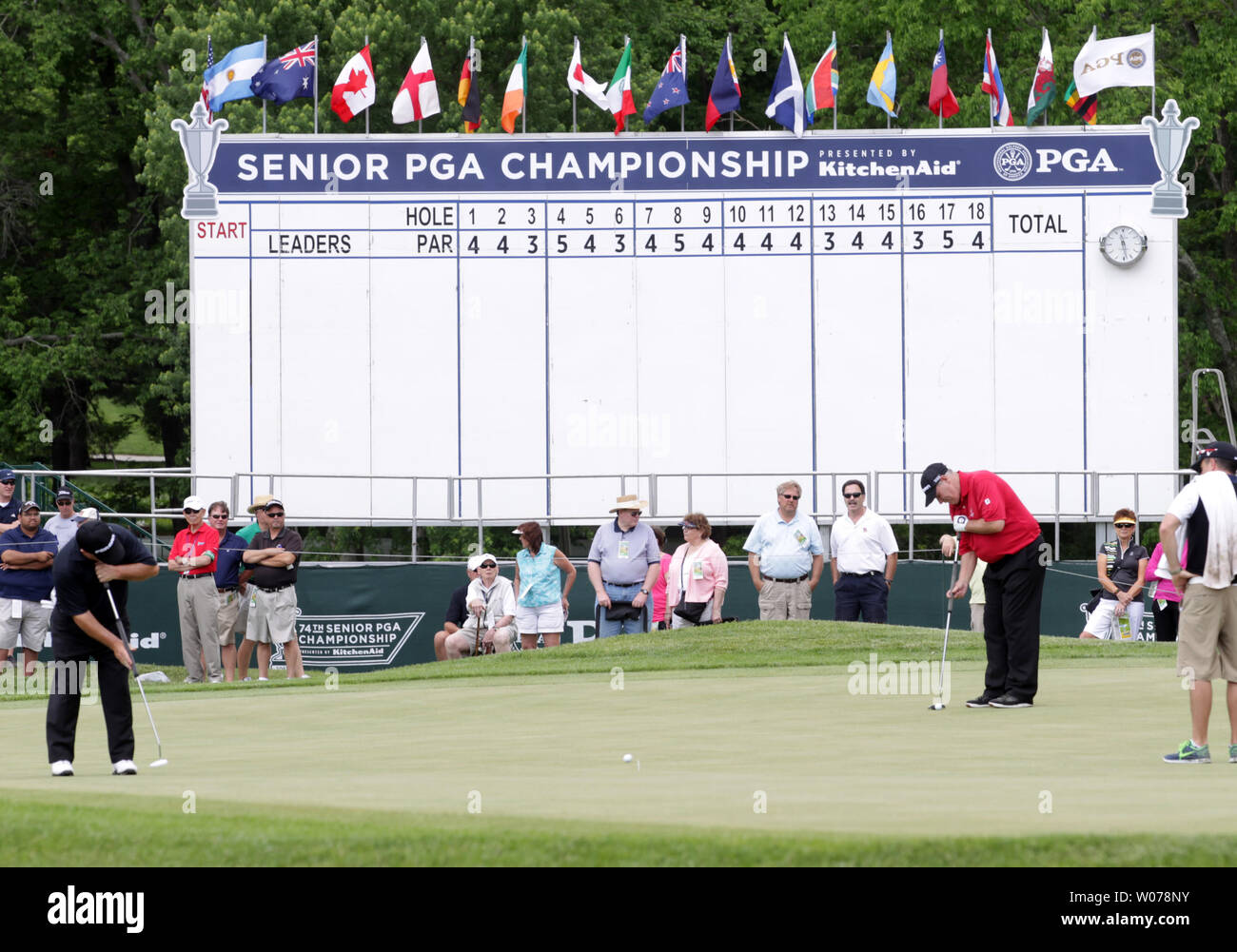 Golfers putt on the 18th hole at the Bellerive Country Club during a ...