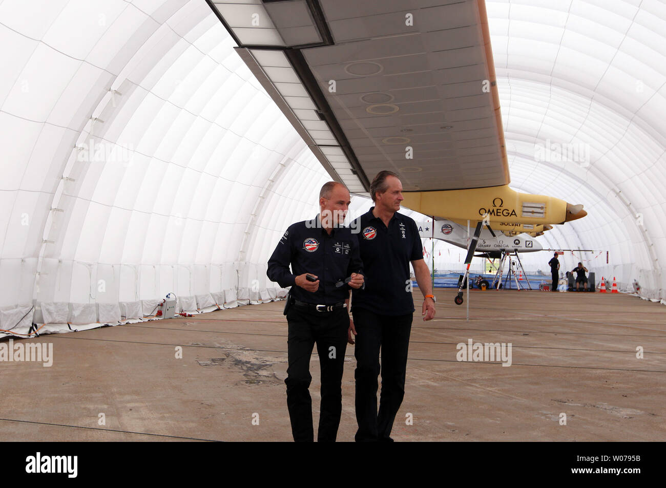 Solar Impulse pilots Bertrand Piccard (L) and Andre Borschberg walk in ...