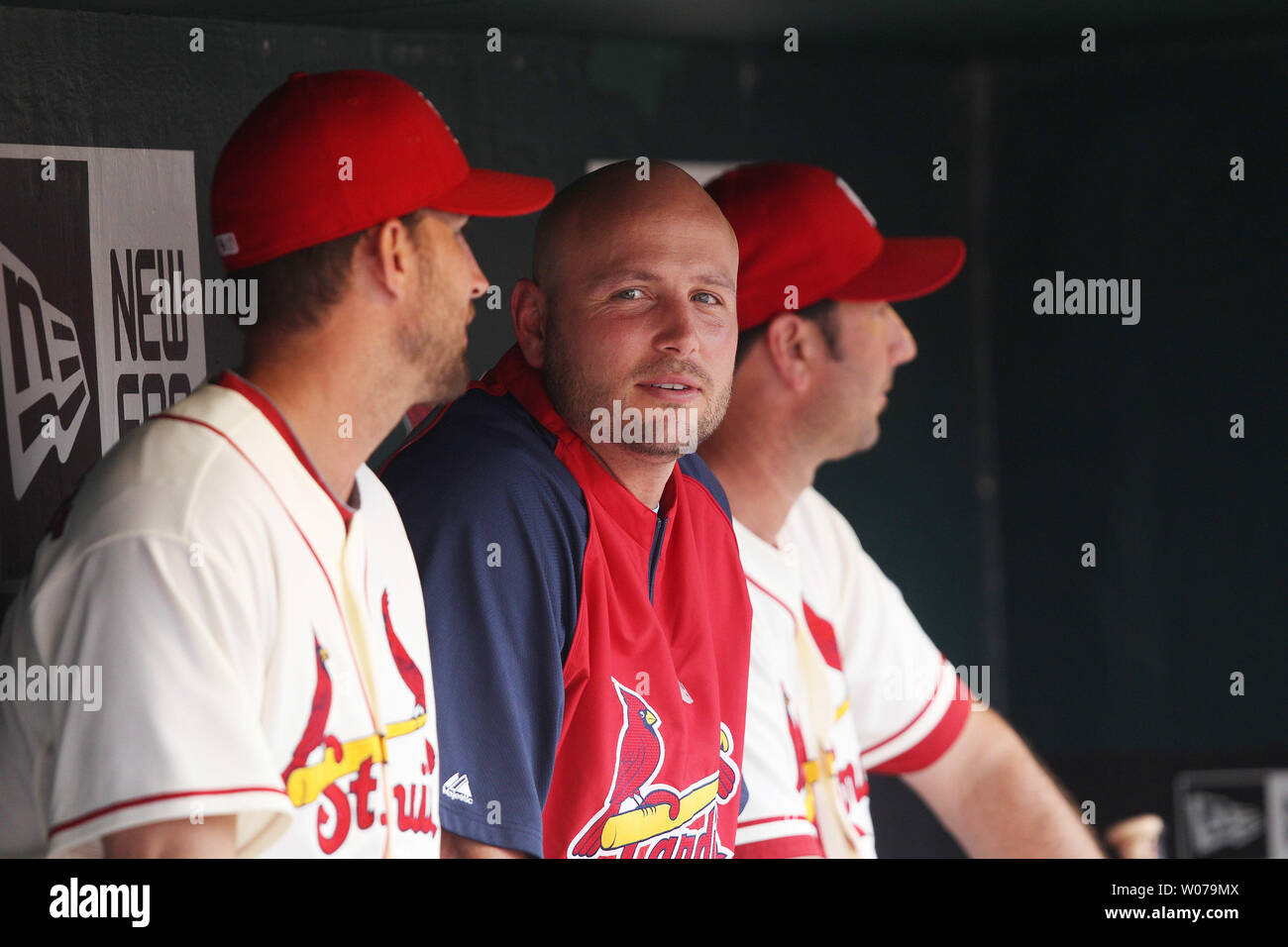 St. Louis Cardinals Matt Holliday (C) talks with pitcher Adam ...