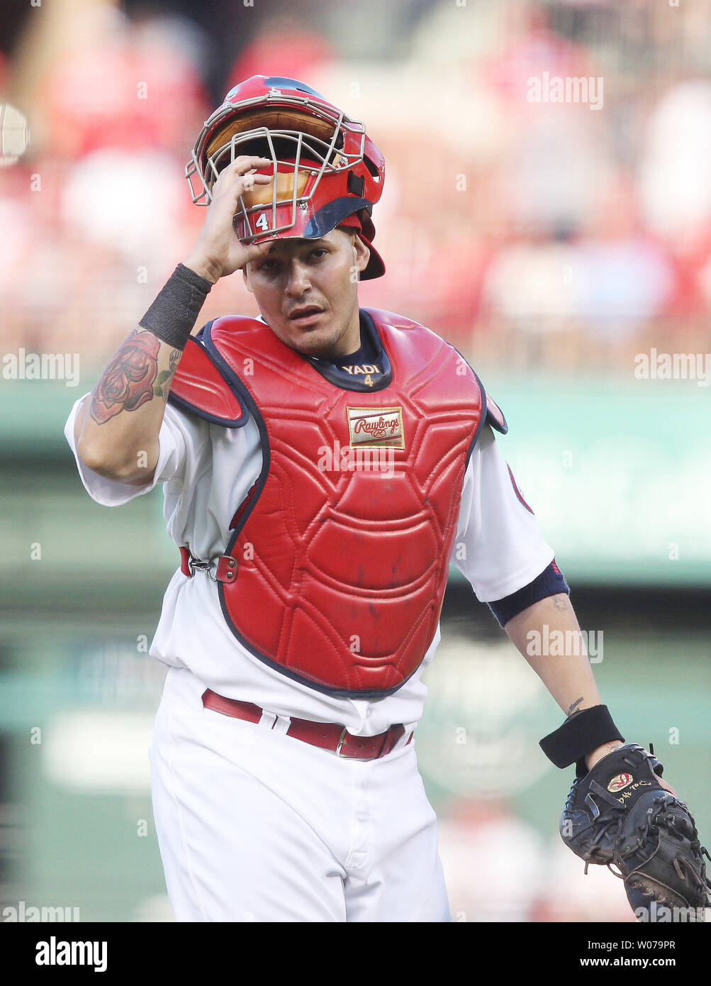 St. Louis Cardinals catcher Yadier Molina adjusts his mask as he ...