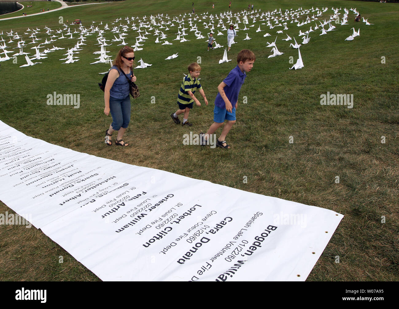 Visitors to Art Hill in Forest Park, walk up the hill next to names of ...