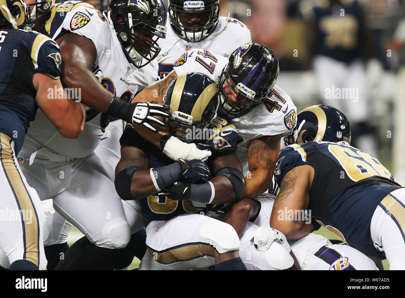 St. Louis Rams Zack Stacy is wrapped up by the Baltimore Ravens defense ...