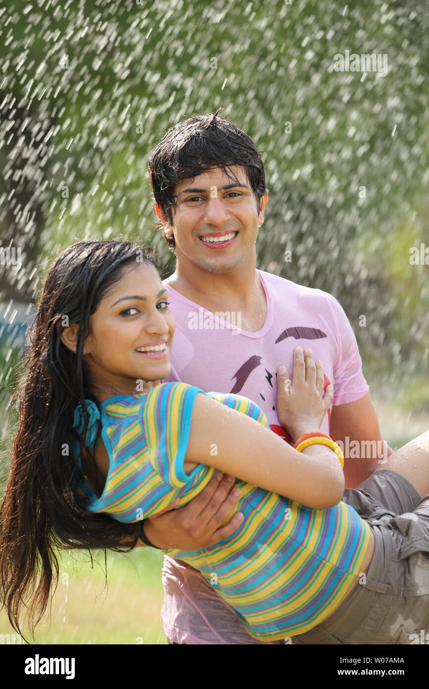 Portrait of an Indian couple romancing in the rain Stock Photo - Alamy