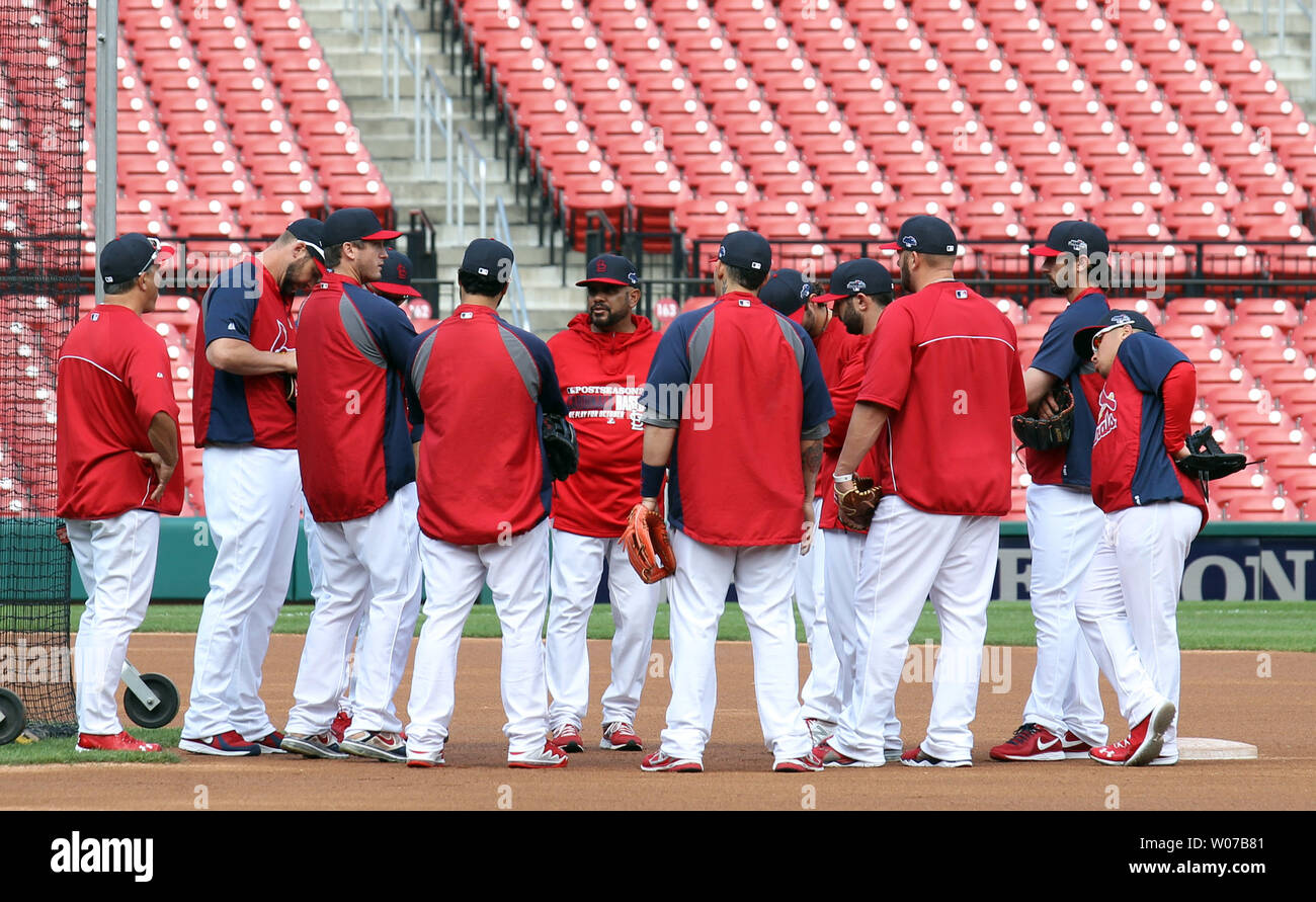 St. Louis Cardinals position players gather around third base coach ...