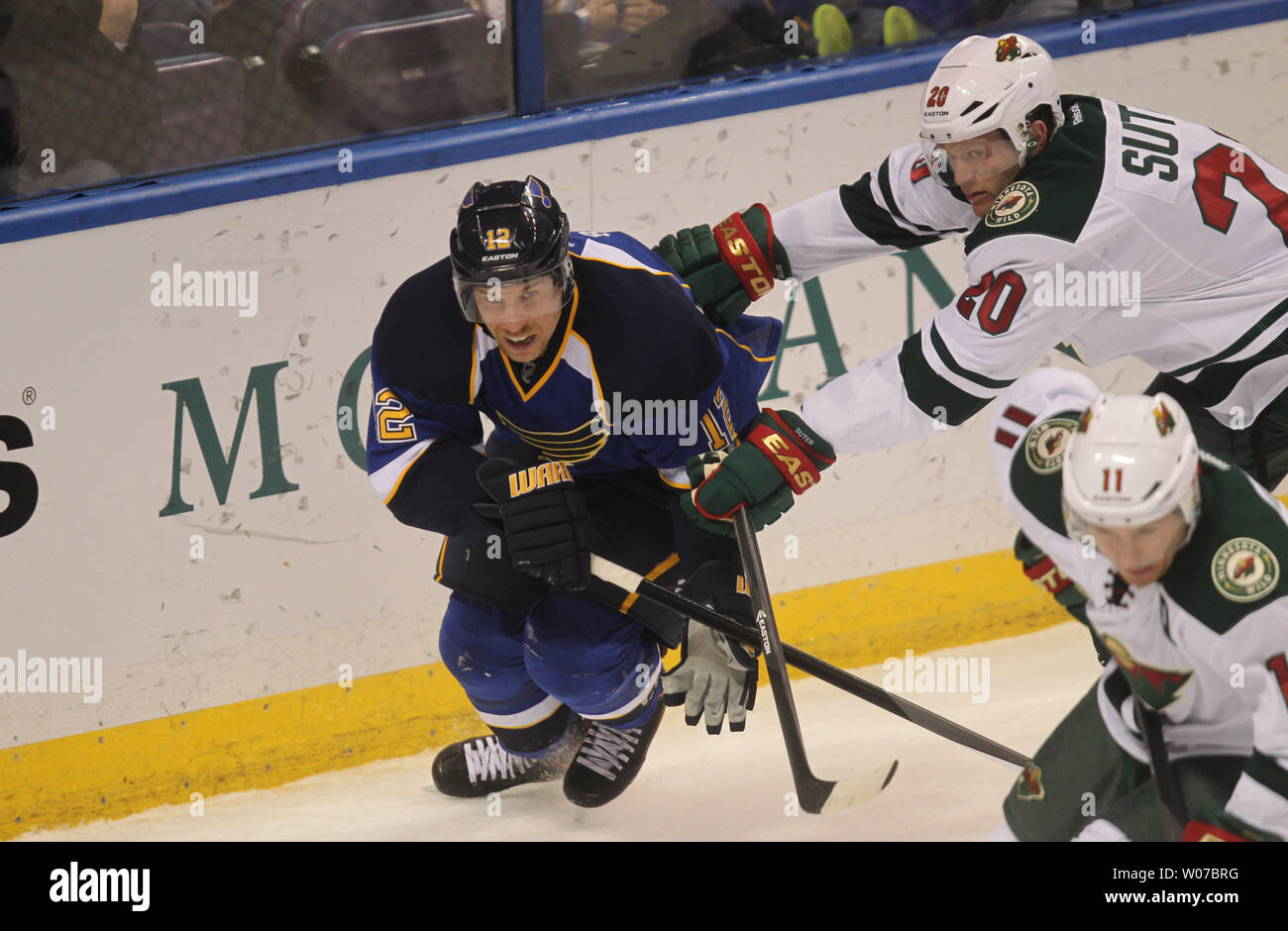 St. Louis Blues Derek Roy (12) is forced to the ice by Minnesota Wild ...