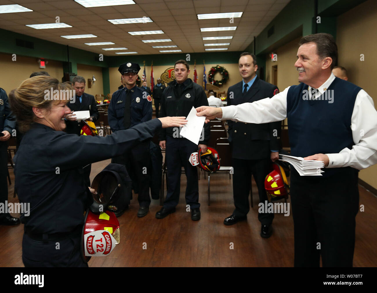 St. Louis firefighter Lori Riley takes her promotion letter from fire ...
