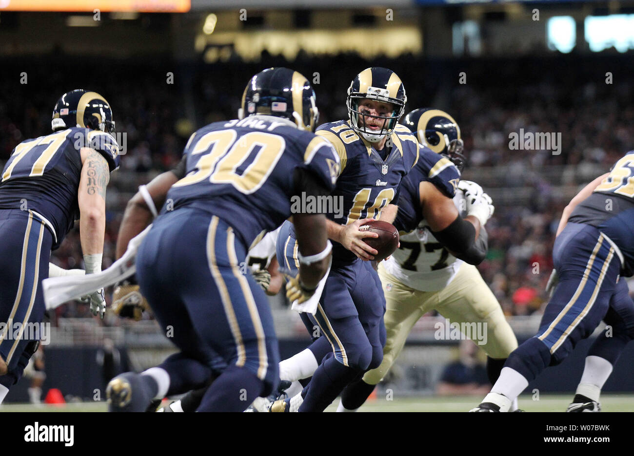 St. Louis Rams Kellen Clemens hands the football off to Zac Stacy in ...