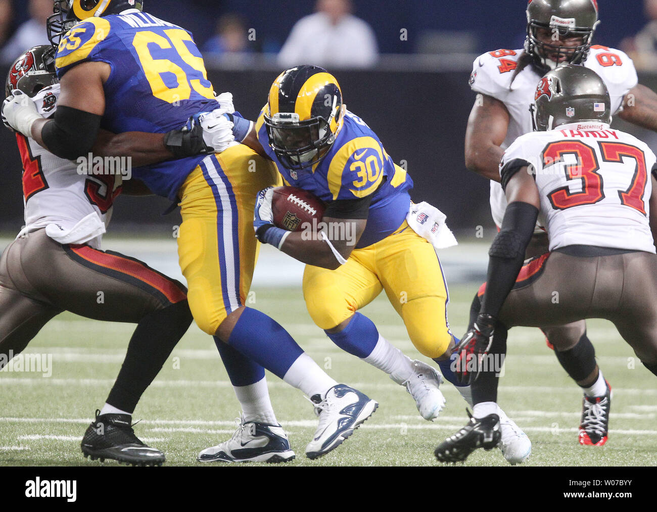 St. Louis Rams Zac Stacy makes his way through a hole in the first ...