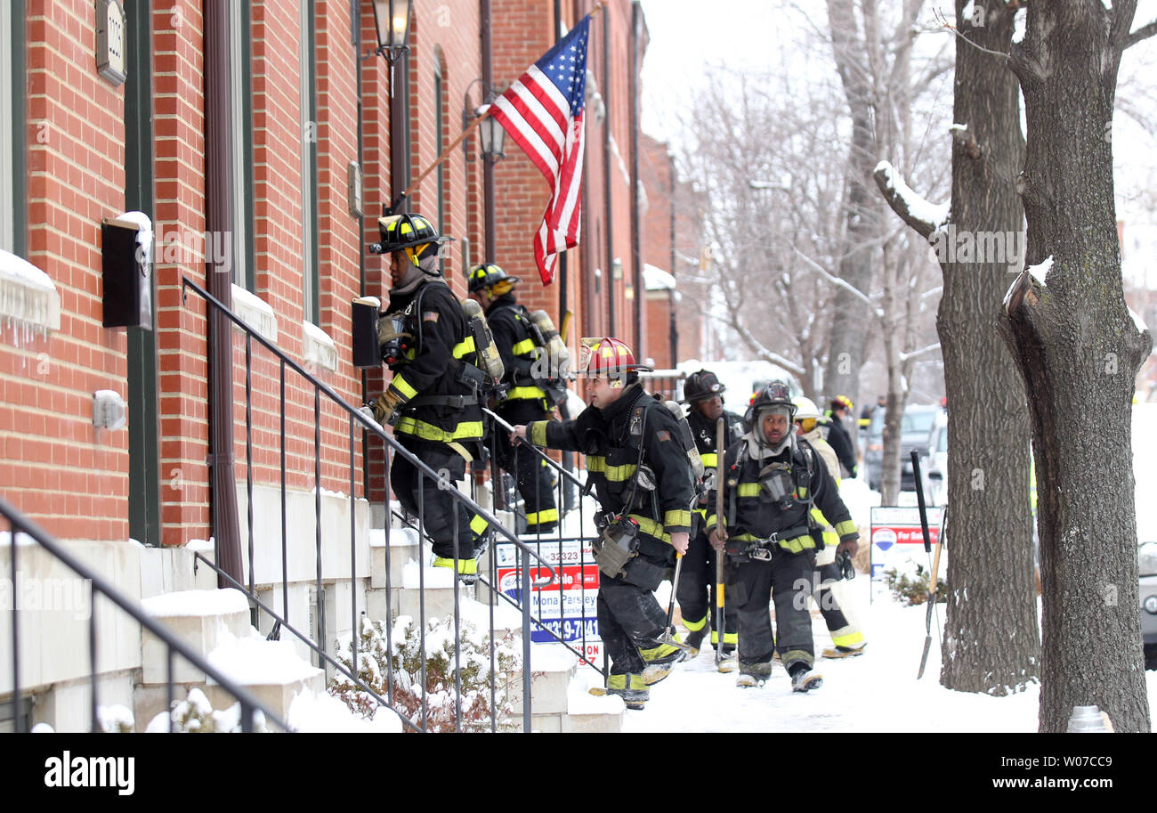 St. Louis firefighters enter apartments to evacuate residents and to ...