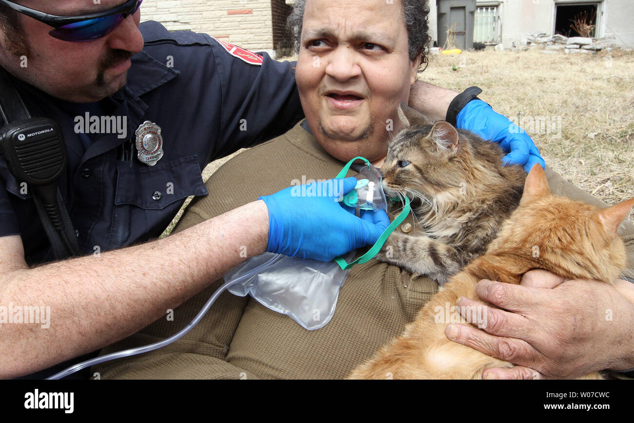 St. Louis Paramedic Matt Sleet delivers oxygen to Harry the cat as home ...
